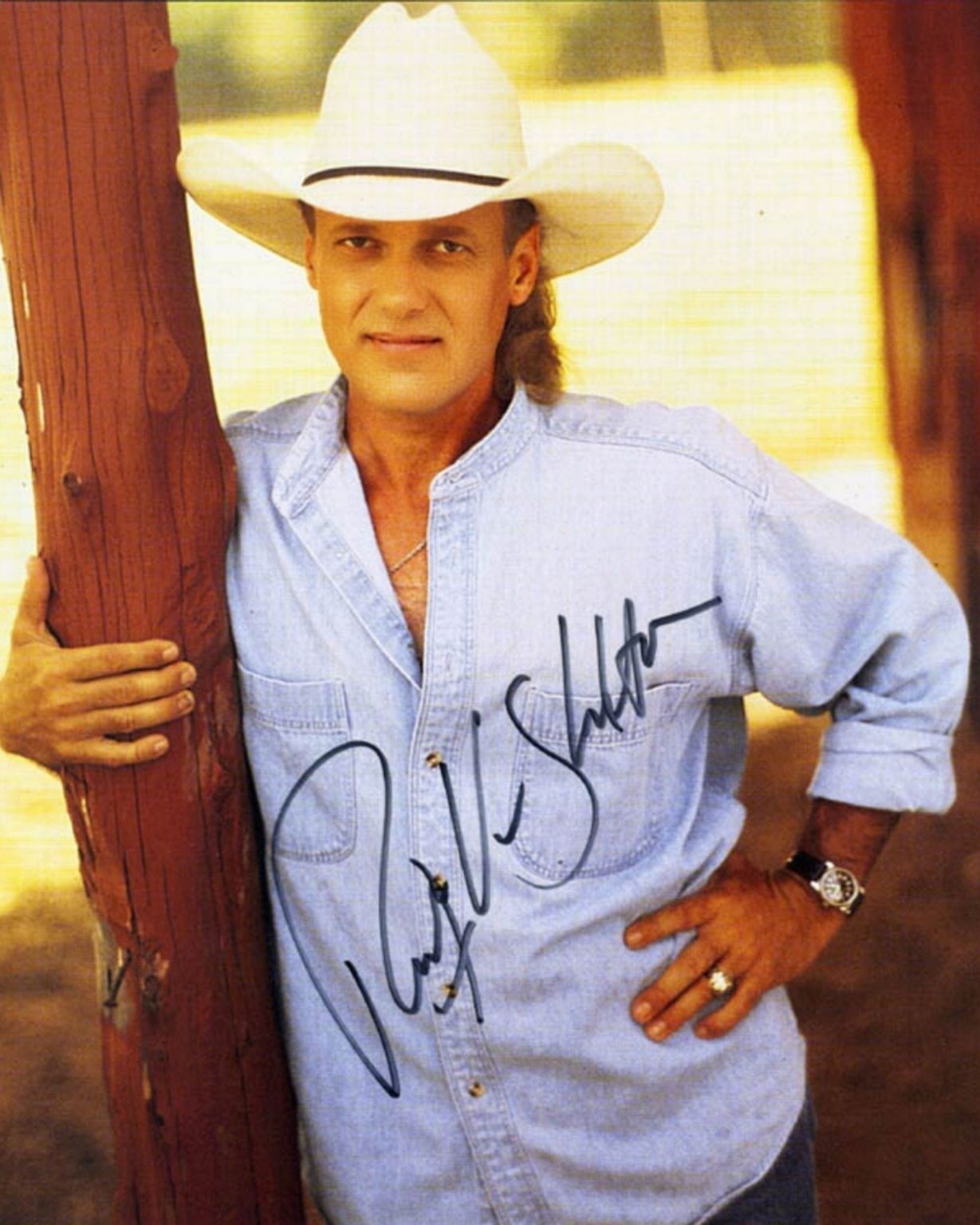 With a white cowboy hat and simple denim shirt, Ricky leans against a ...